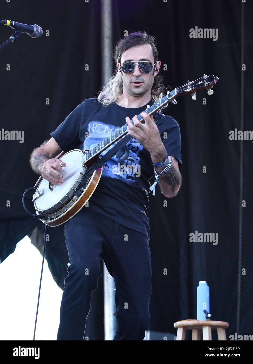 Banjo player Kyle Tuttle is shown performing on stage during a “live ...