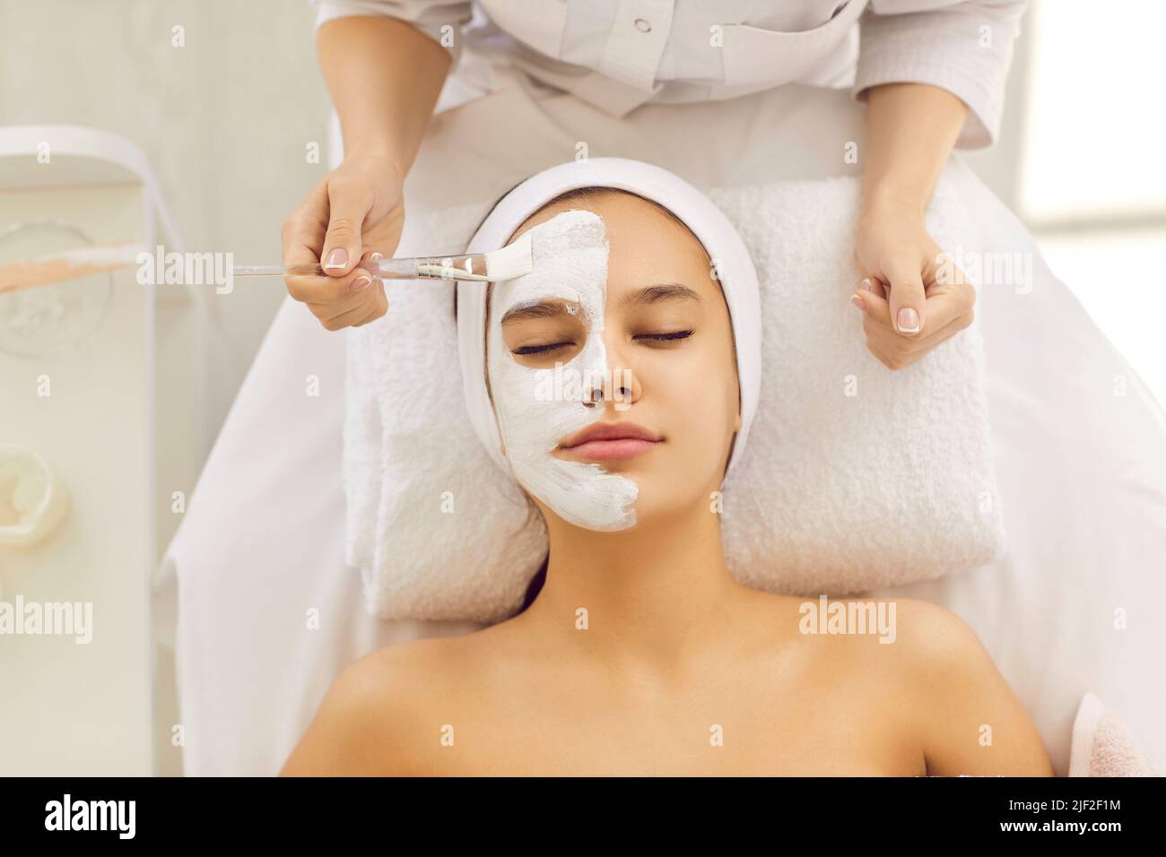 Cosmetologist make beauty procedures to woman client Stock Photo - Alamy