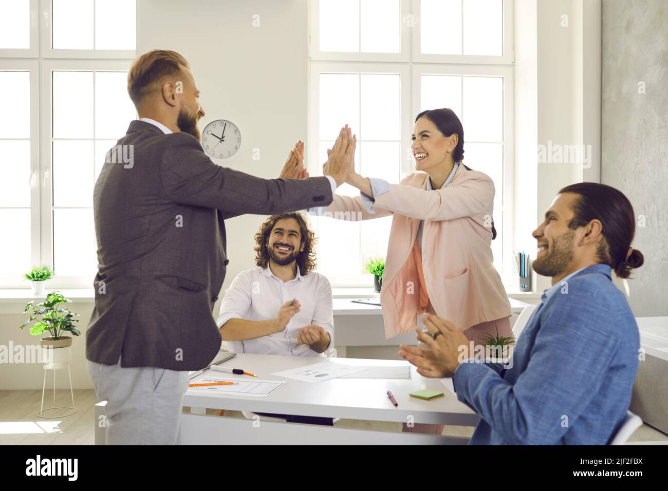 Teams of happy business people making deal, smiling and giving each ...