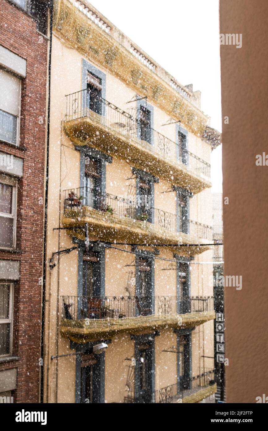 Rain storm water drops falling on the street on a urban scene with a ...