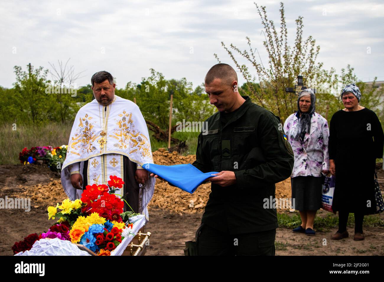 Friend of†Sergey Titov gives the Ukrainian flag to the parents. Family, relatives, and friends ...