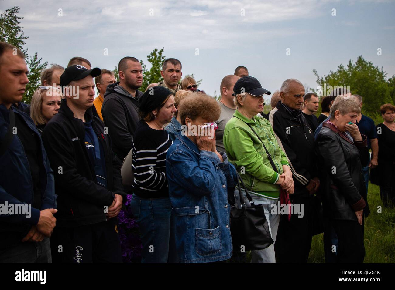 Mourners attend the funeral of Sergey Titov. Family, relatives, and friends are attending the ...