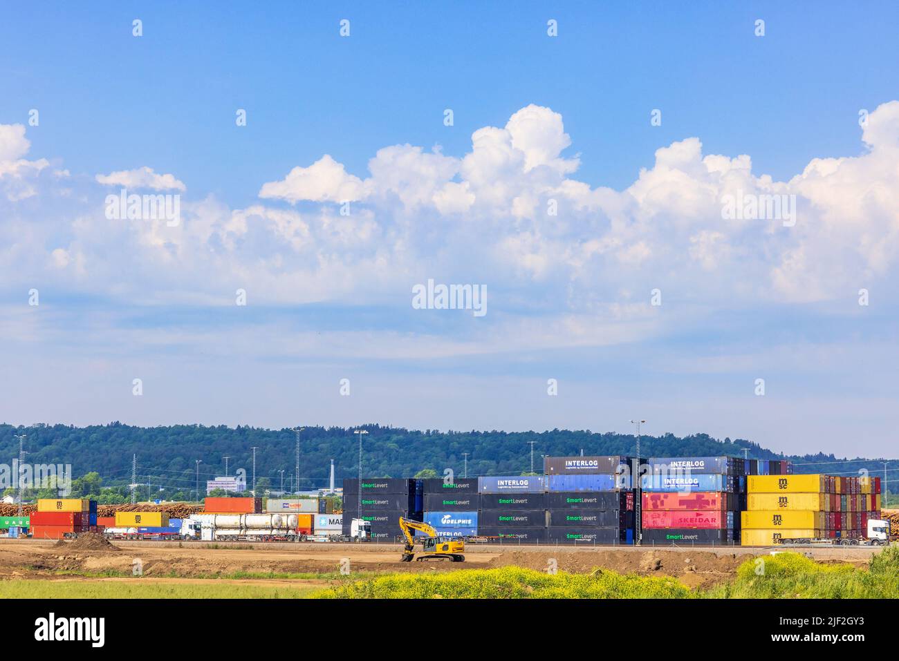 Industrial area with an excavator and shipping containers Stock Photo ...