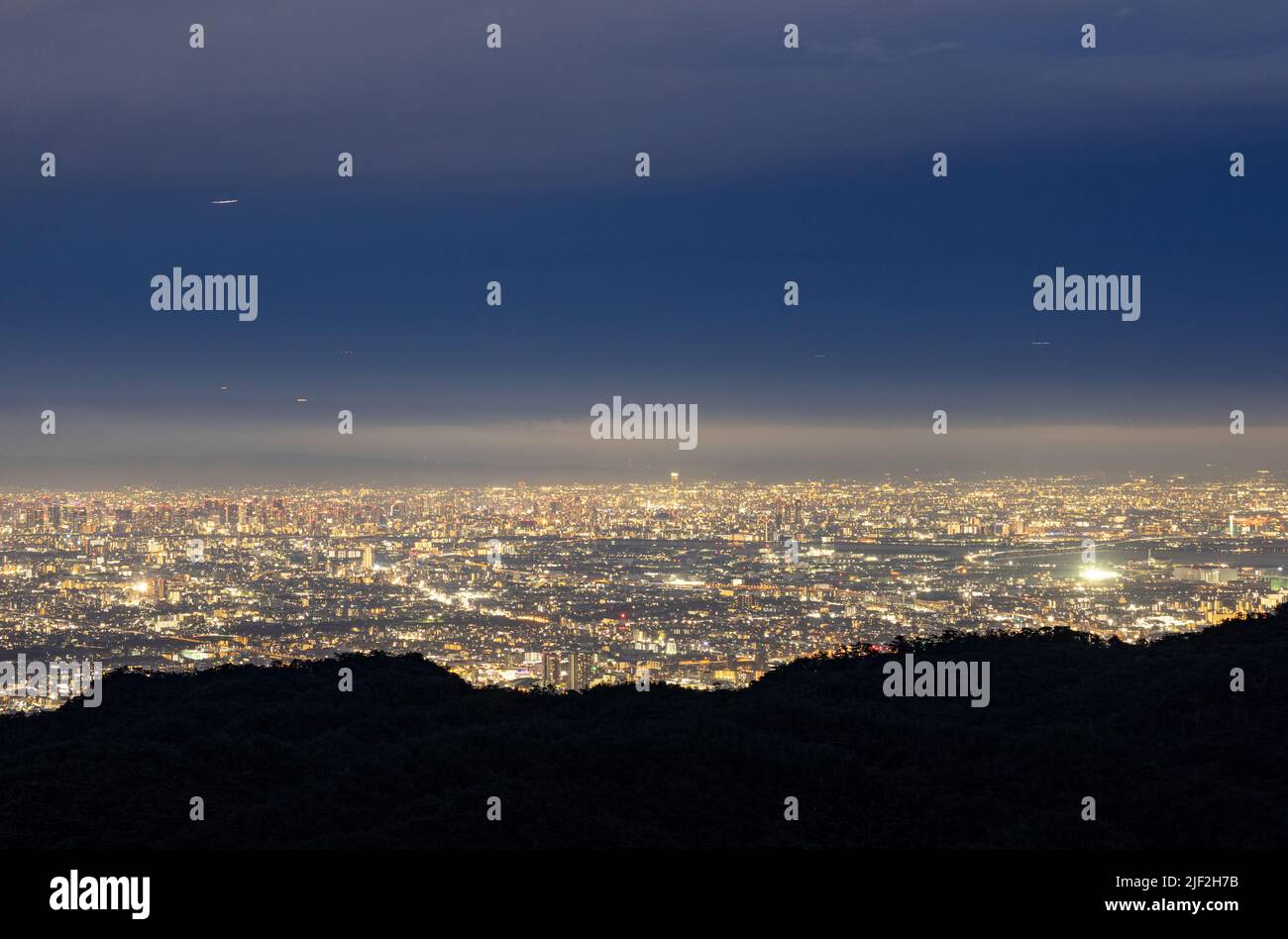 Dark hillside overlooking sprawling city at night Stock Photo - Alamy