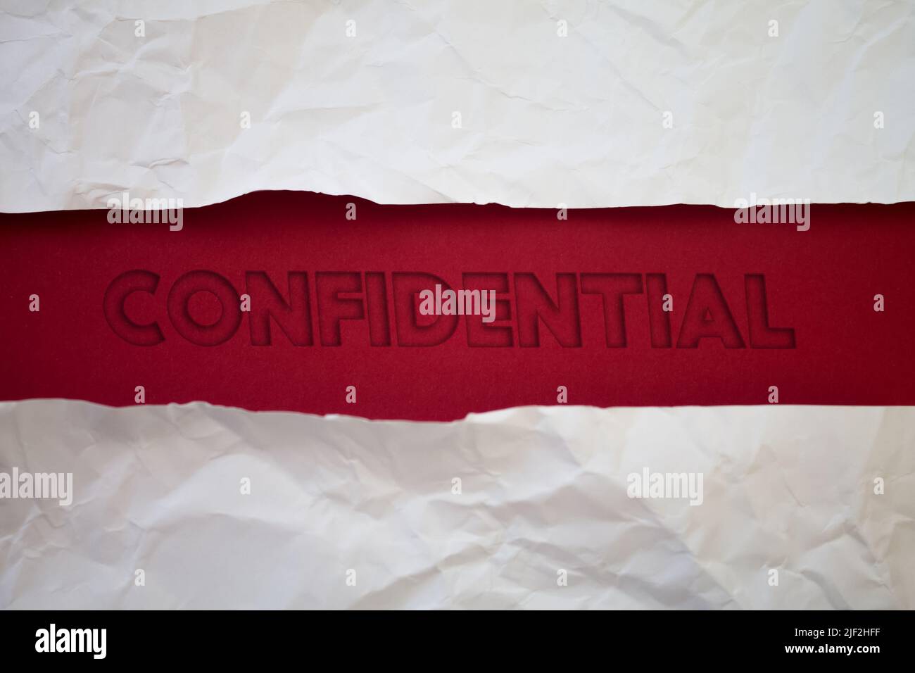 Confidential text with Torn, Crumpled White Paper on colored background ...