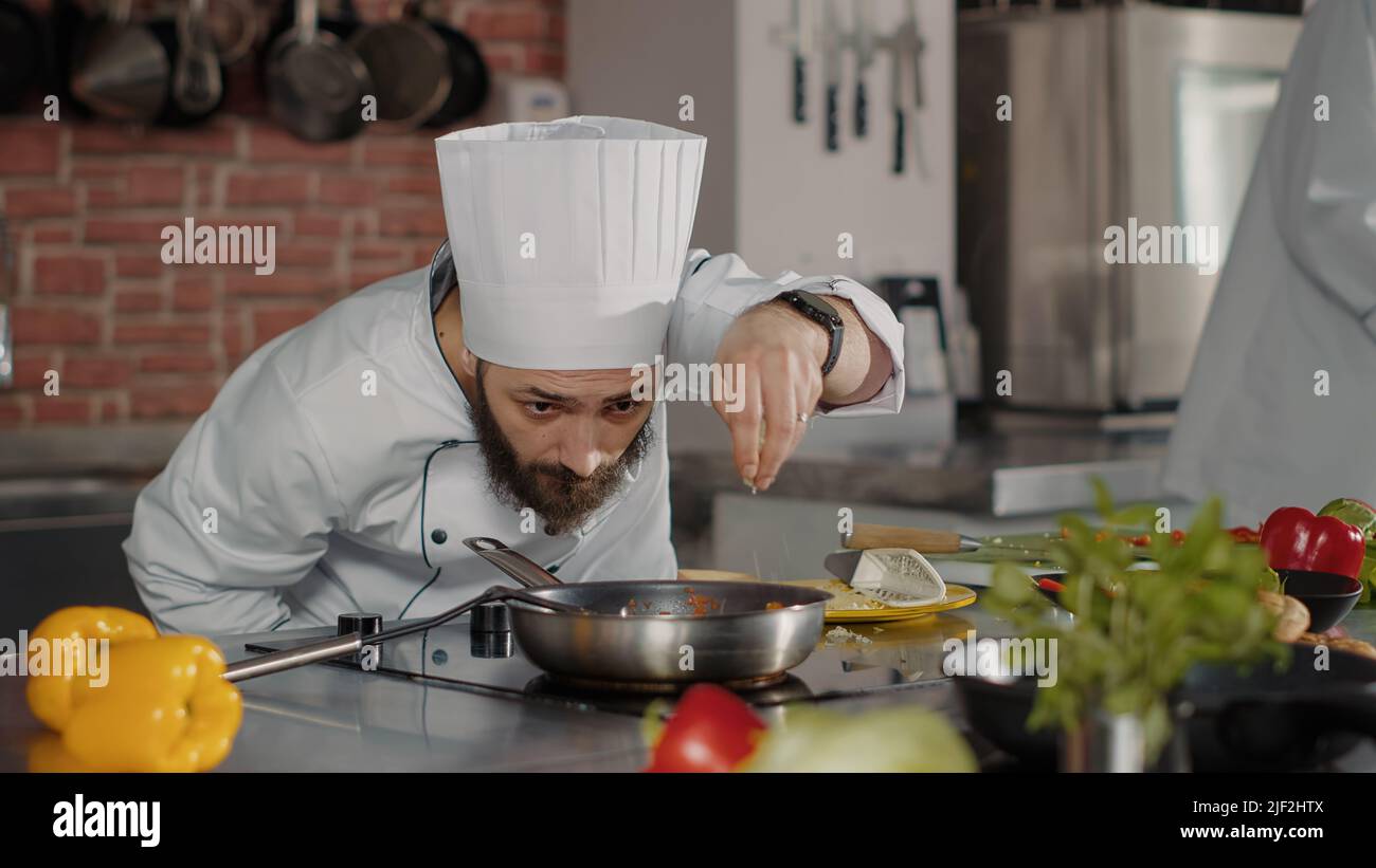 Male chef pouring shredded cheese hi-res stock photography and images ...