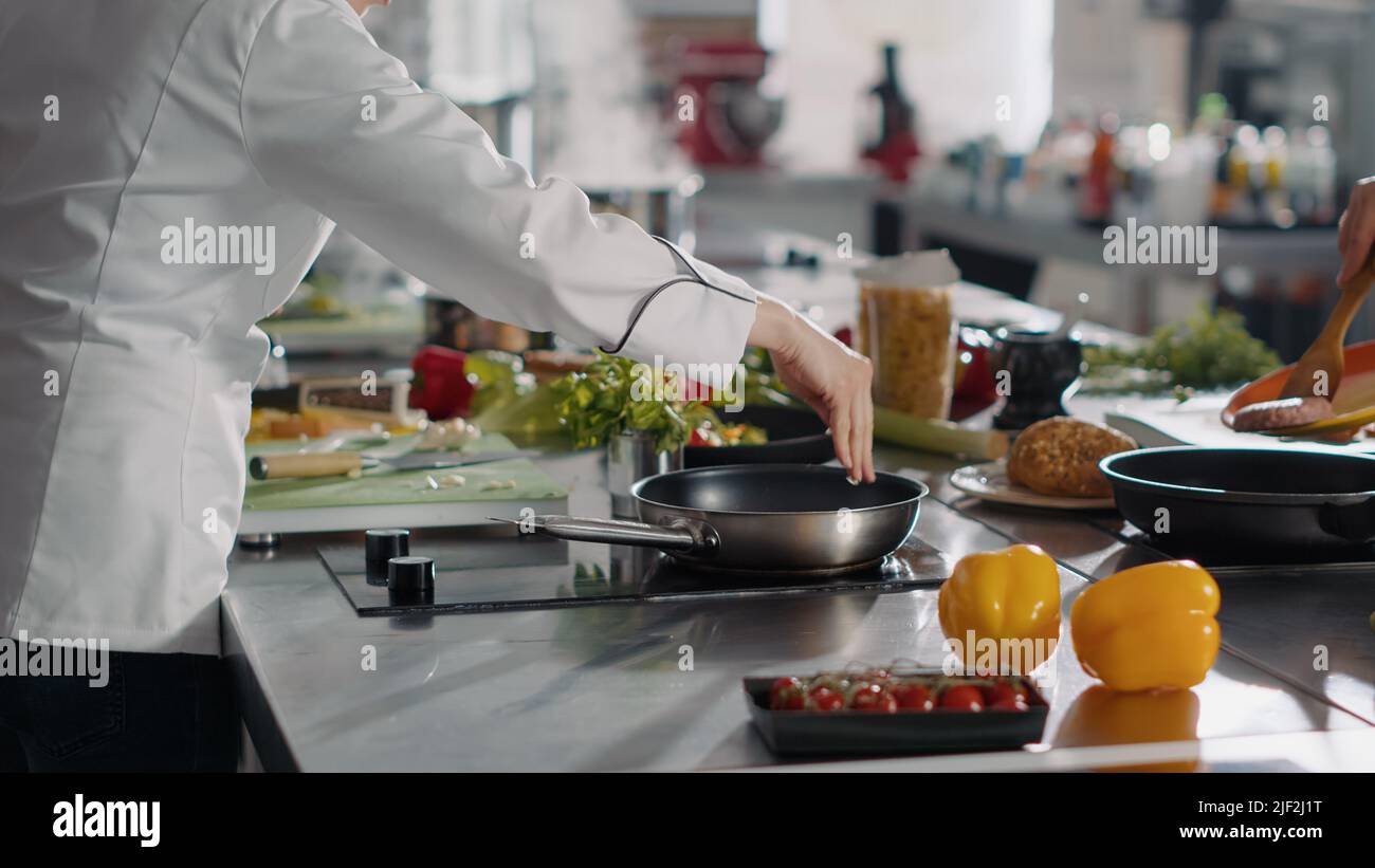 Pan shot woman cooking vegetable hi-res stock photography and images ...