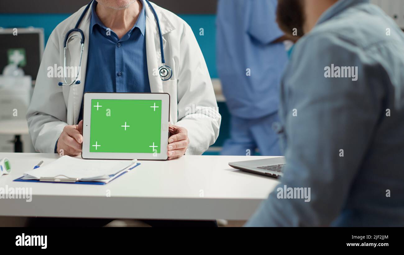Health specialist showing horizontal greenscreen on tablet, patient ...