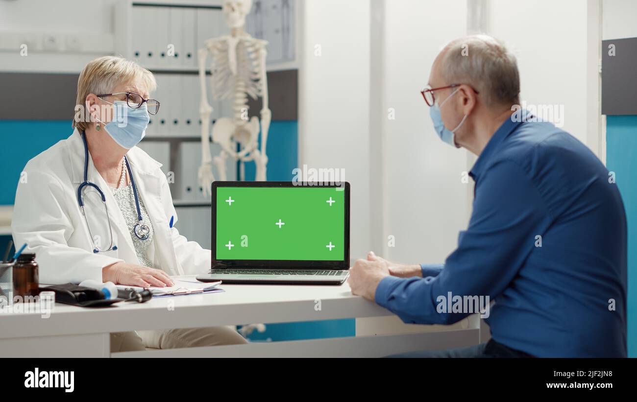 Medical specialist using greenscreen on laptop computer at chekcup ...