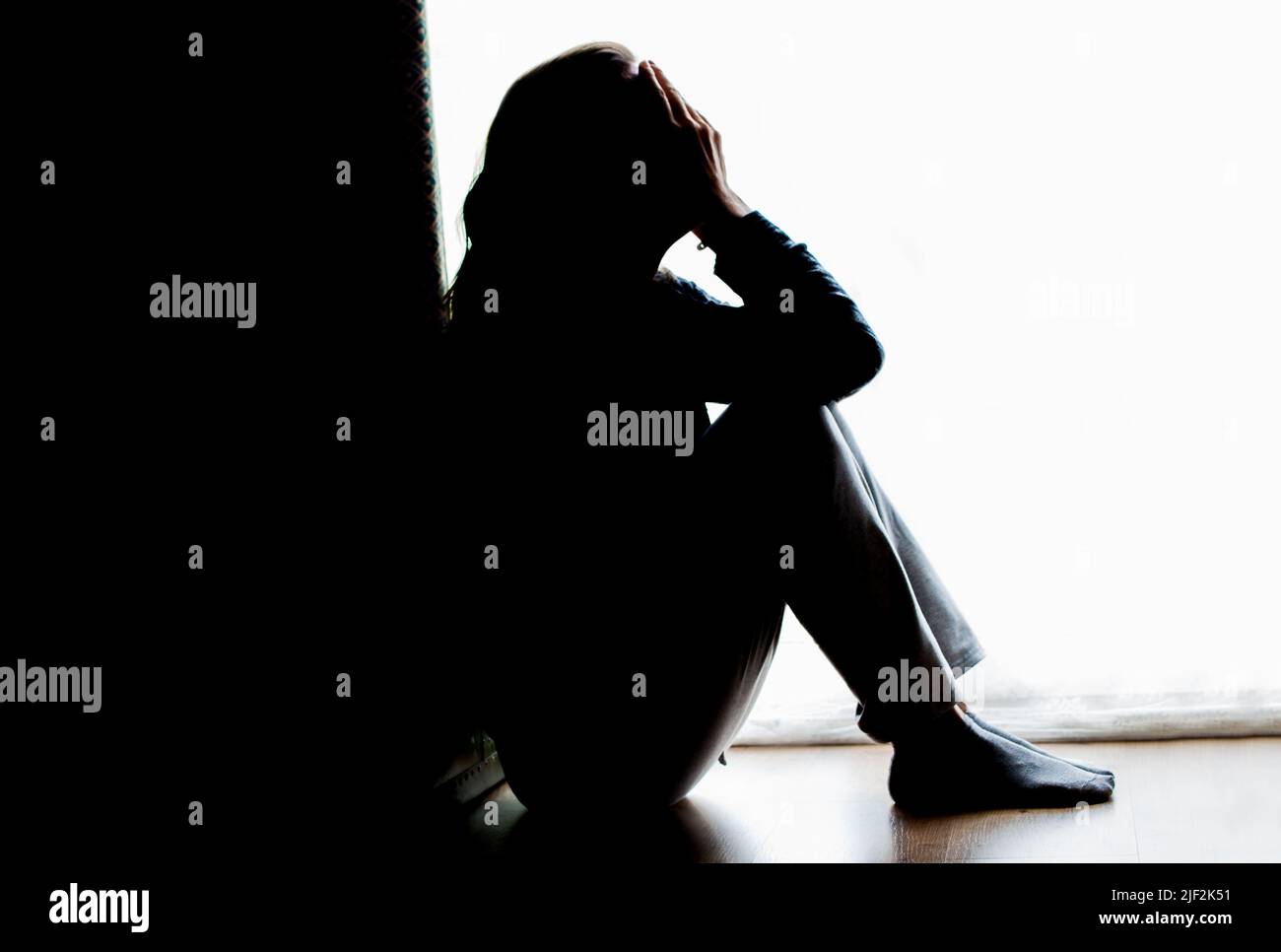 Crying woman silhouette sitting hi-res stock photography and images - Alamy