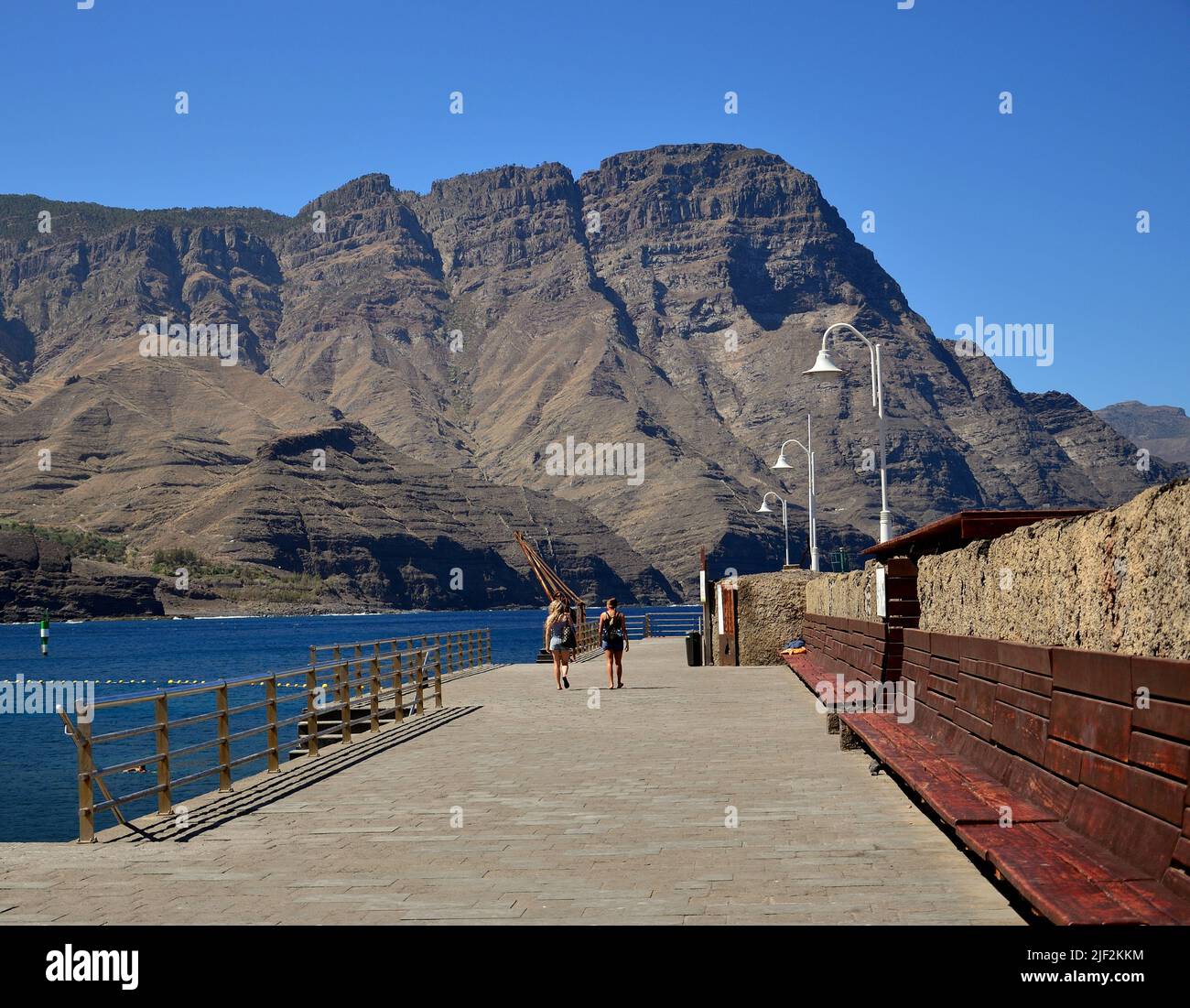 Old fishing dock of Agaete, high cliffs and blue sky, north coast of ...