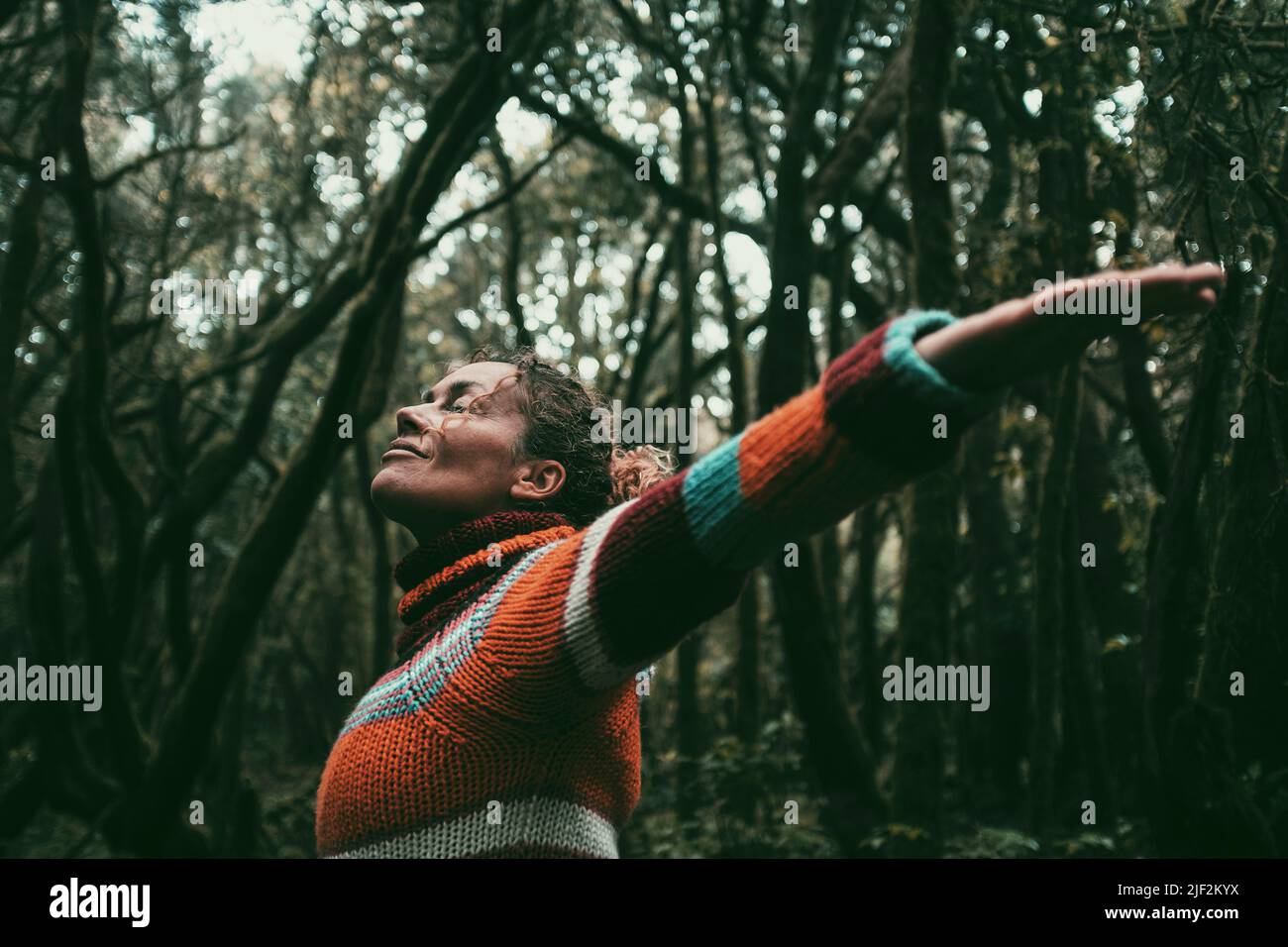 Dark mood Nature lover people in the woods opening arms to embrace ...