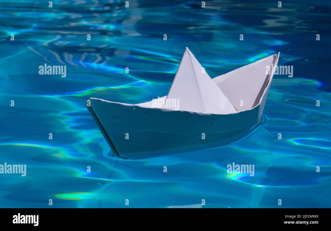 Paper ship. Paper boat in blue sea background. Tourism, travel dreams ...