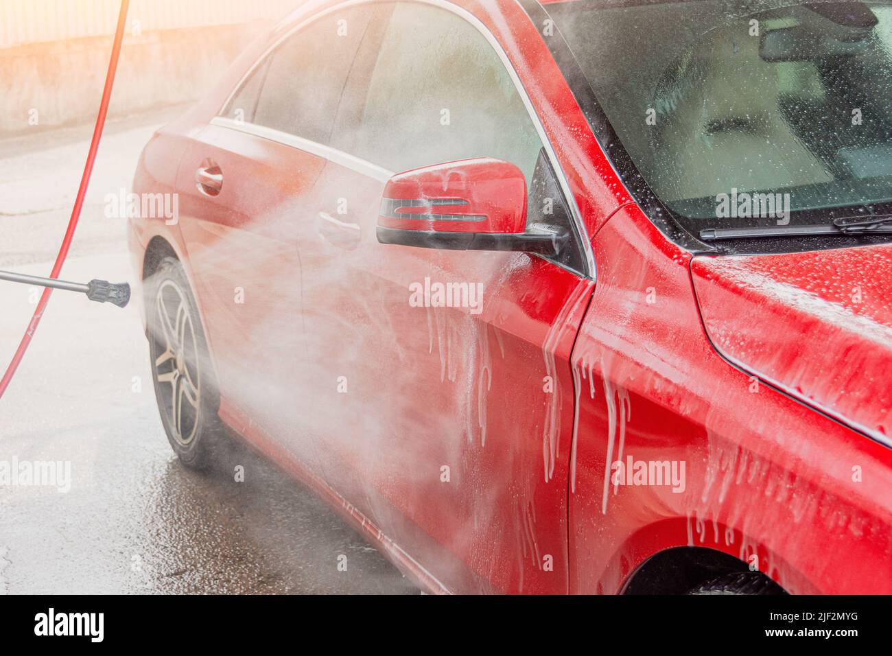 Red car wash with pressure jet side doors and rear view mirror Stock ...