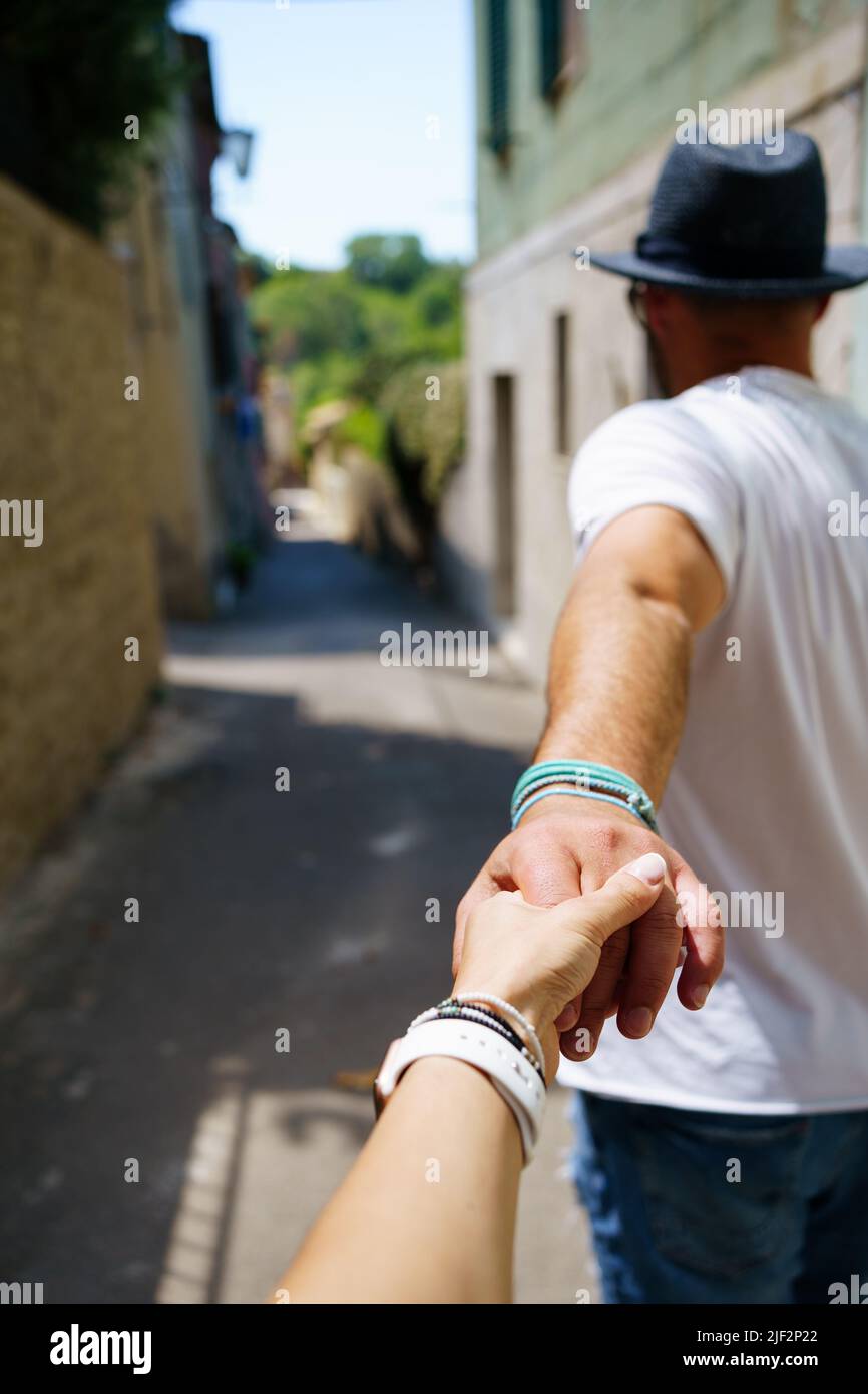 A man leads a girl by the hand behind him. Follow me image Stock Photo ...