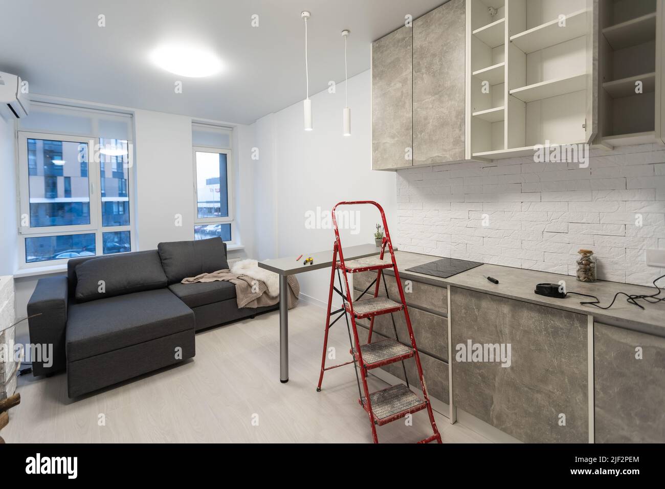 Installing New furniture In Modern Kitchen, ladder Stock Photo - Alamy