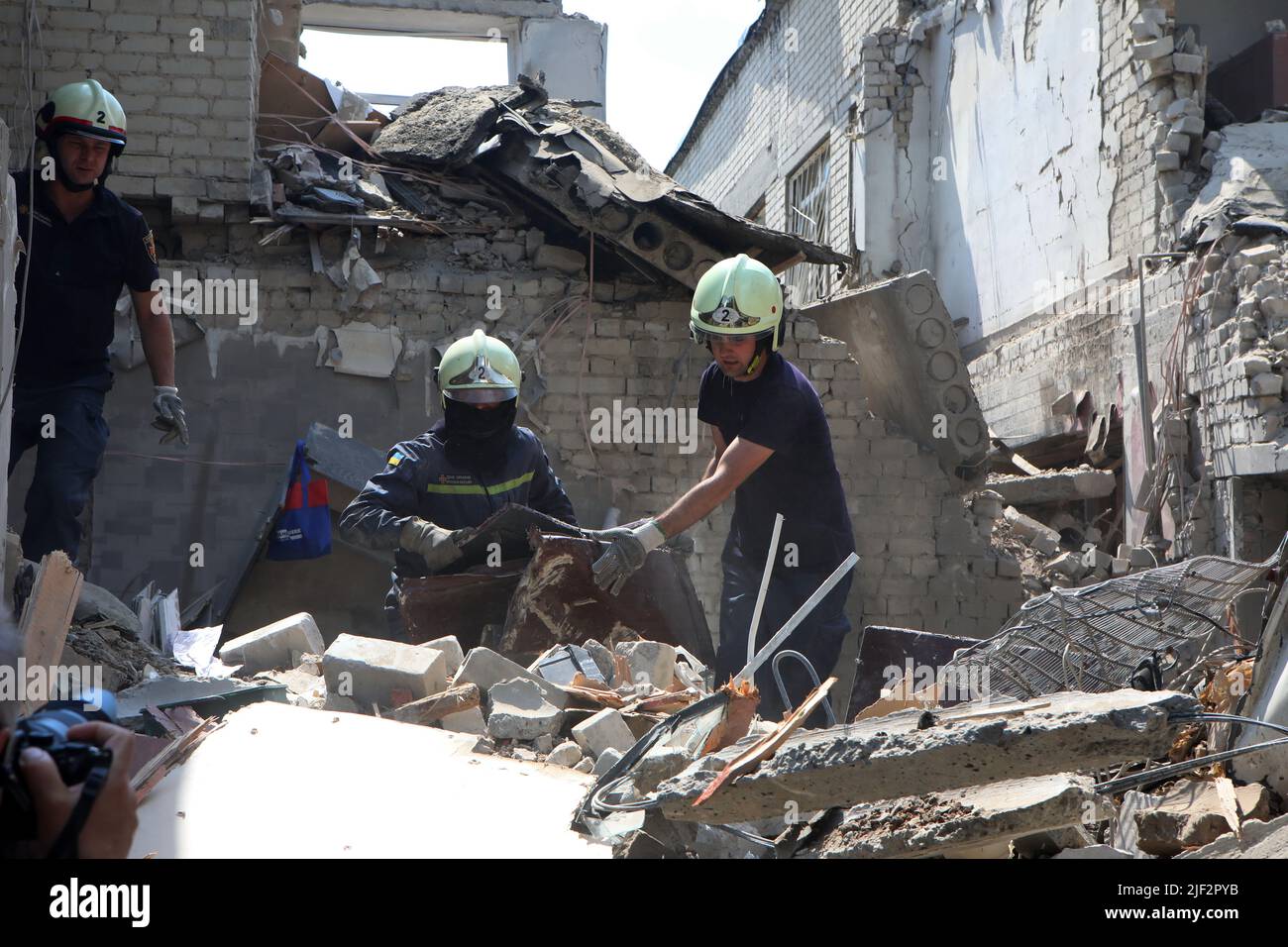 KHARKIV, UKRAINE - JUNE 28, 2022 - Rescuers remove the rubble after a ...