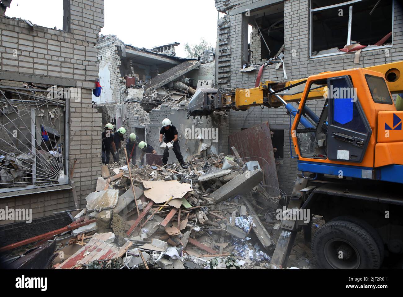KHARKIV, UKRAINE - JUNE 28, 2022 - Rescuers remove the rubble after a Russian missile attack on ...