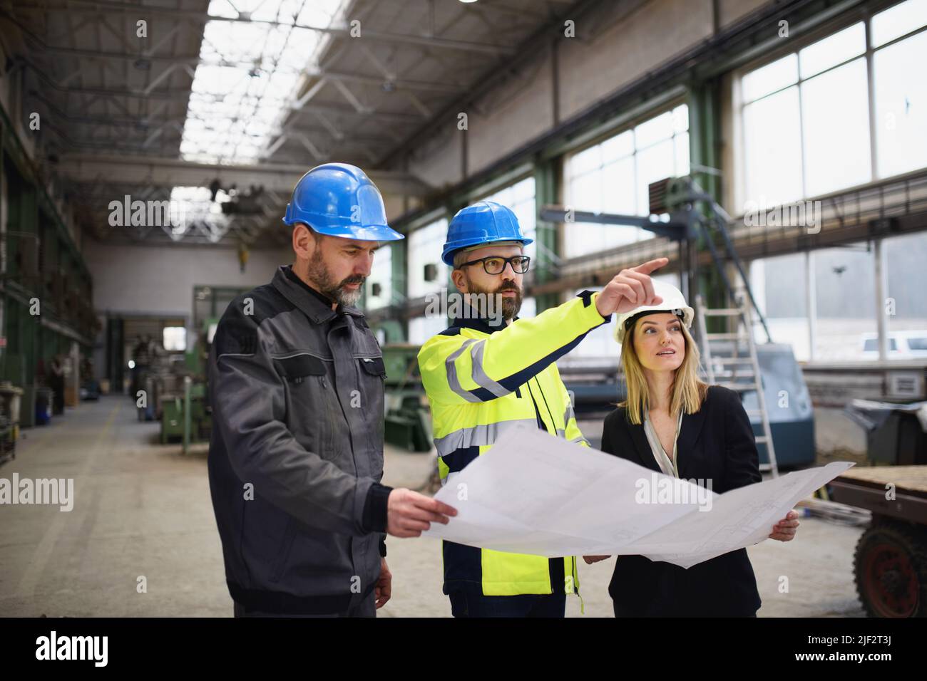 Manager supervisor, engineer and industrial worker in uniform ...