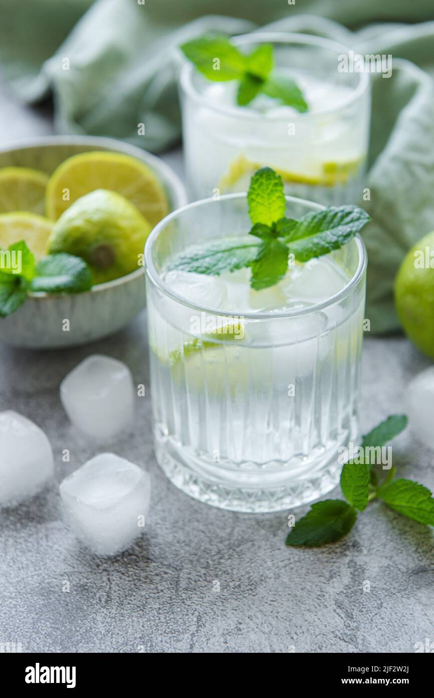 Iced cold lemonade with fresh lime and juice. Summer drink in glass ...