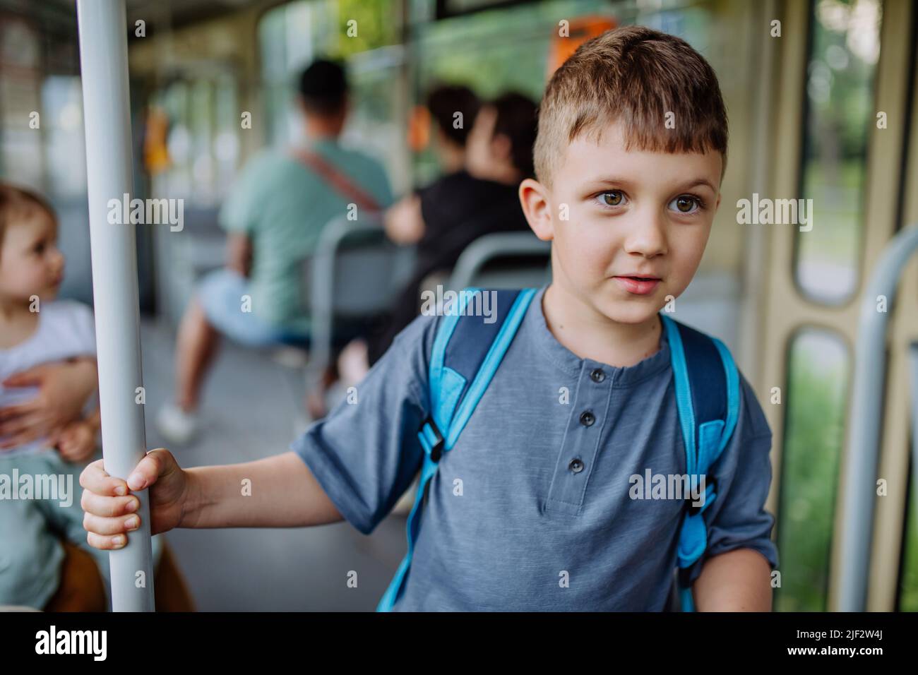 Close-up of little boy travelling to school by bus in the morning ...