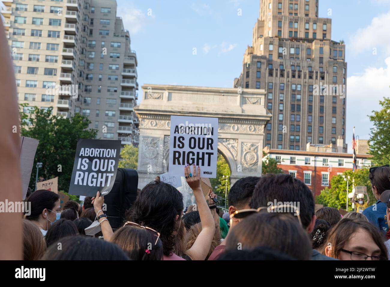 A crowd of protesters holding demonstration signs after Supreme Court ...