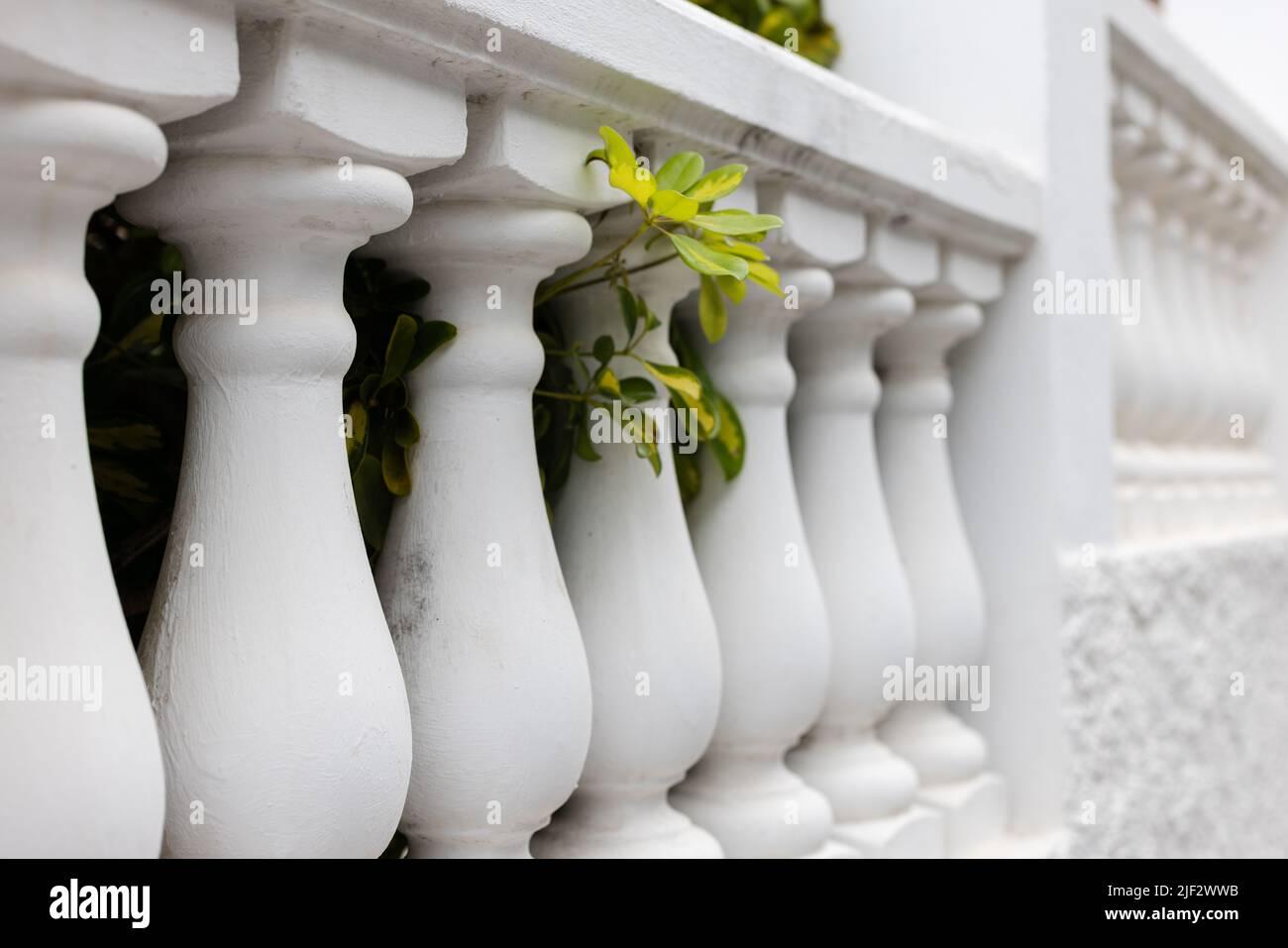 White stone columns wall fence railing with garden behind Stock Photo ...