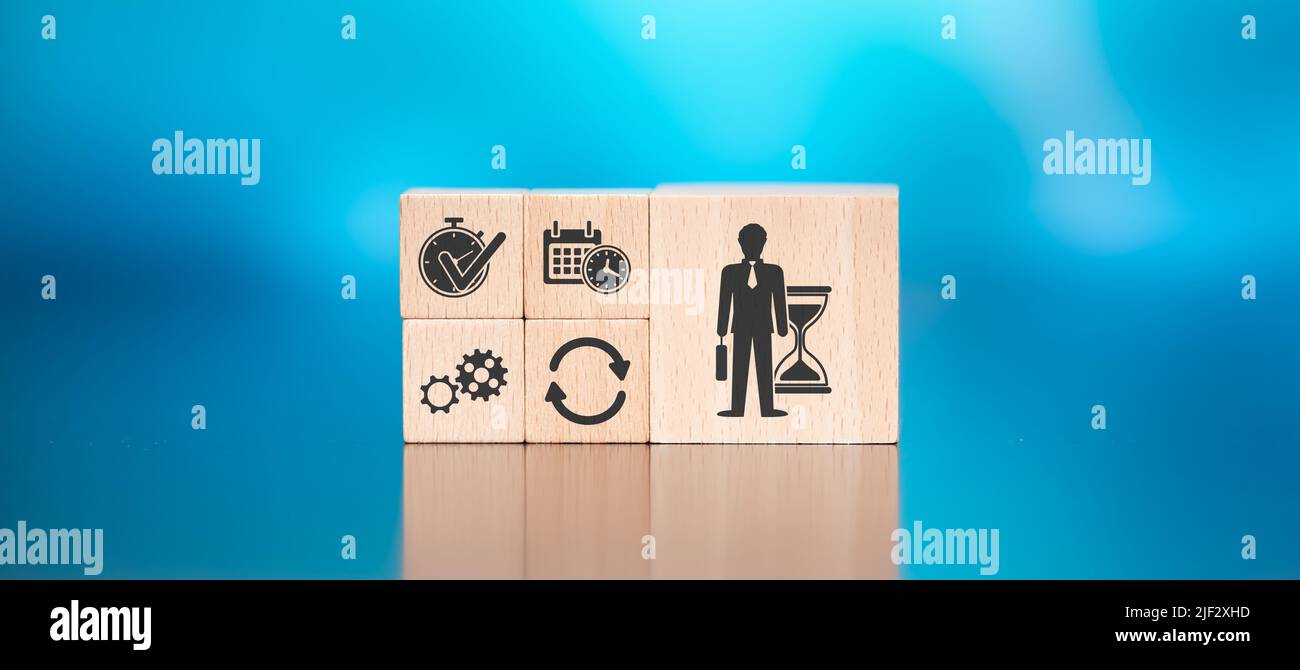 Wooden blocks with symbol of time management concept on blue background ...