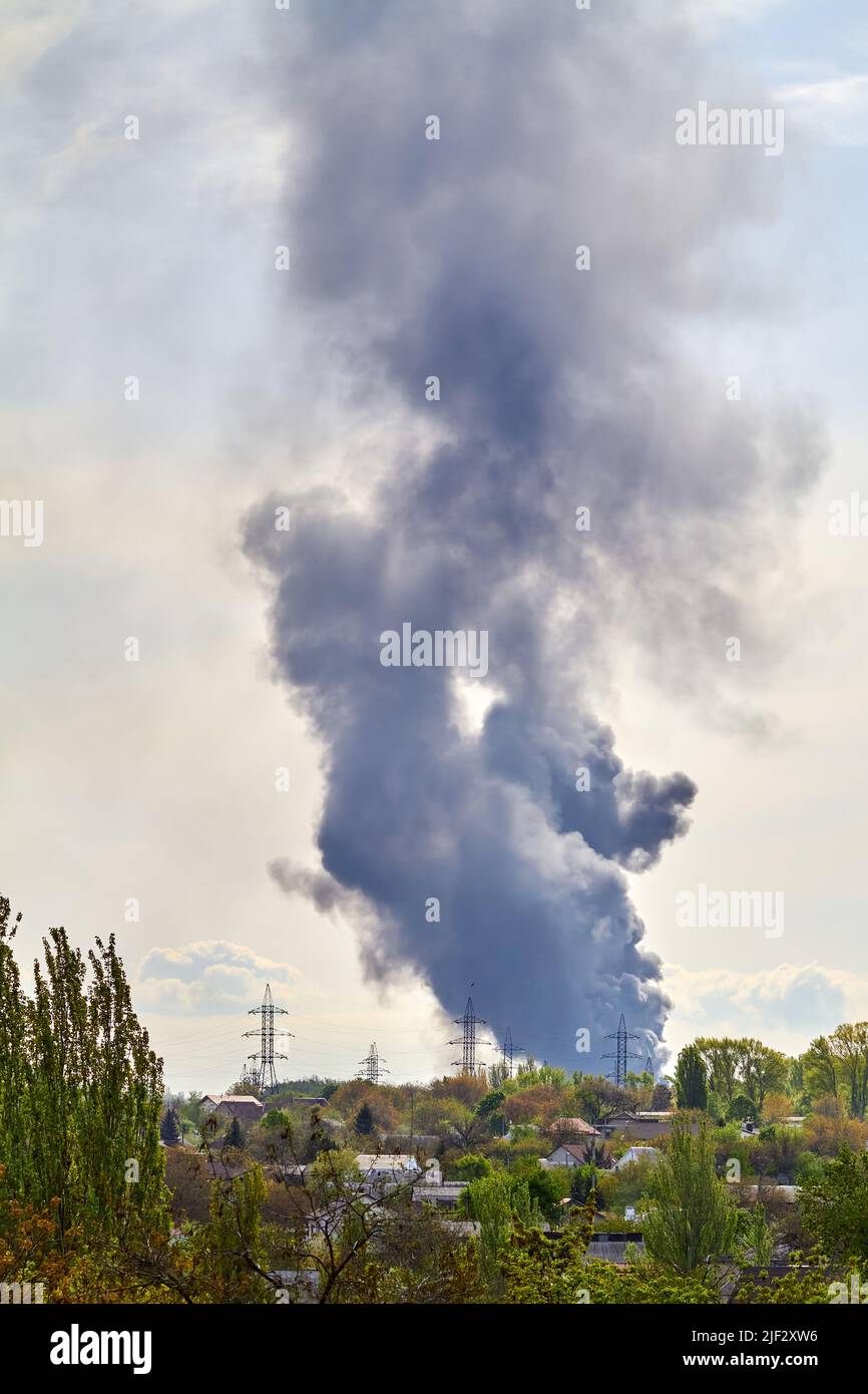 Burning tanks with fuel at the oil depot as a result of a rocket hit ...
