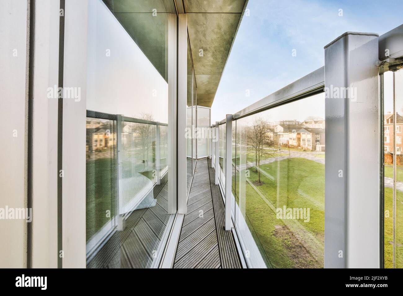 Narrow brick balcony with metal railings, wooden chair and door Stock ...