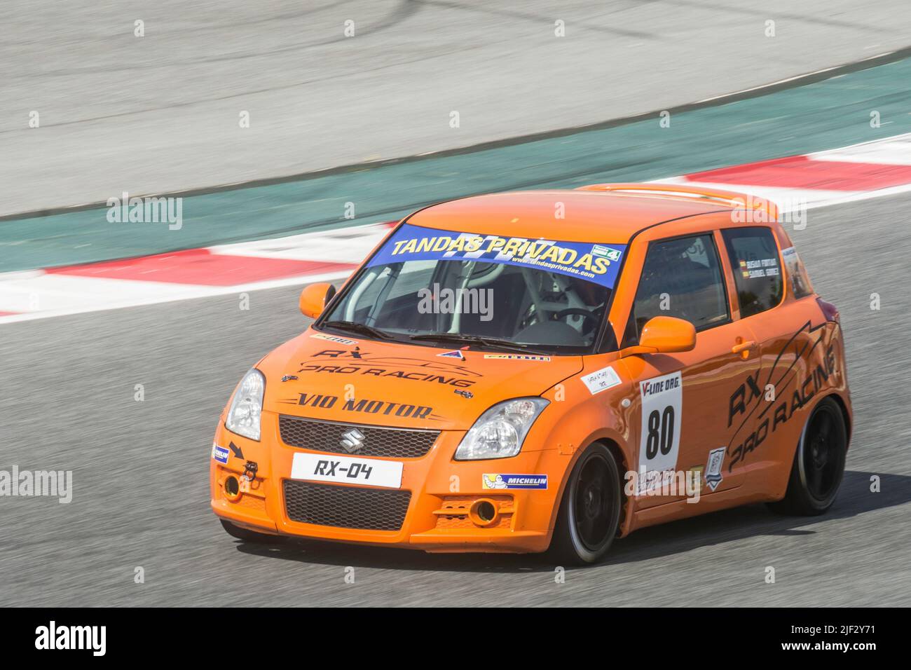 Little japan orange FWD car in the track. Suzuki Swift Stock Photo - Alamy