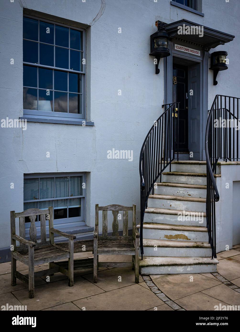 A vertical shot of the quay house with small stairs and two wooden ...