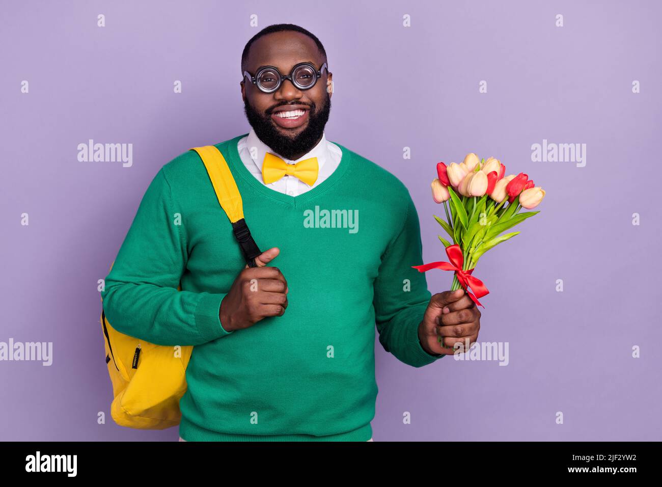 Photo of cheerful satisfied person carry backpack hold fresh flowers ...