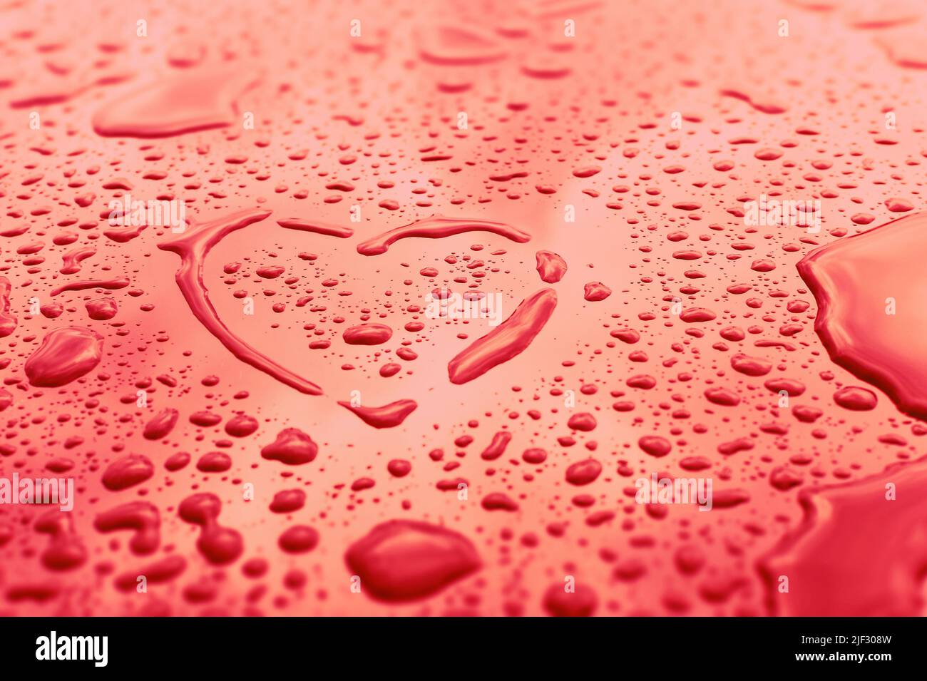 Heart made of water drops on a glass mirror. The symbol of love and ...