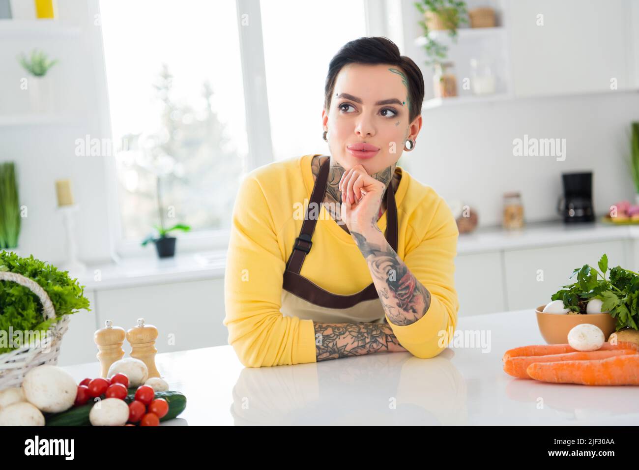 Photo of young charming vegetarian female with tattoo piercing thinking ...