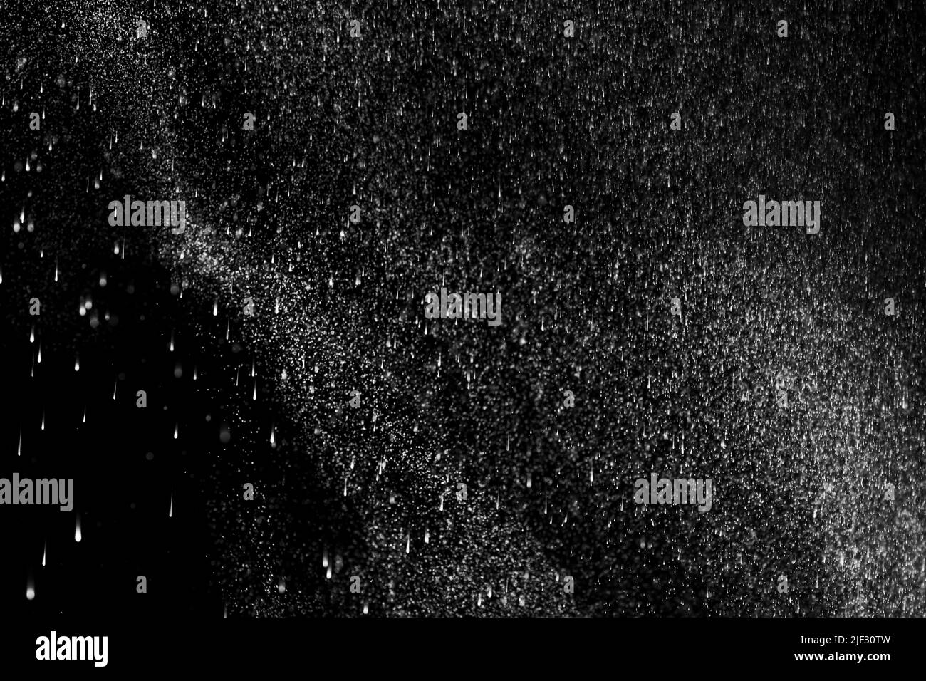 Abstract cloud with falling drops isolated on black background. White ...