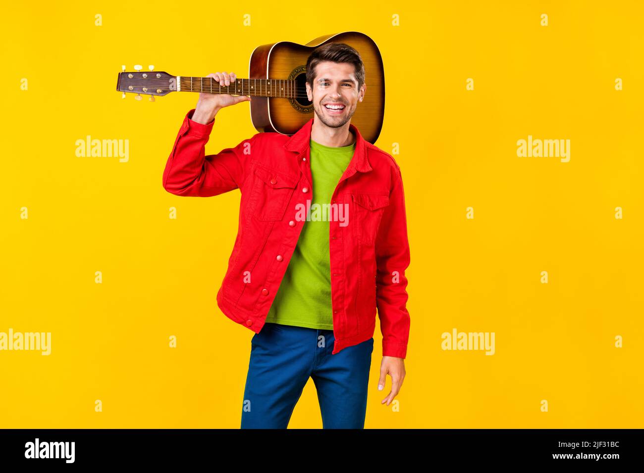 Portrait of attractive cheerful cool guy holding guitar spending ...