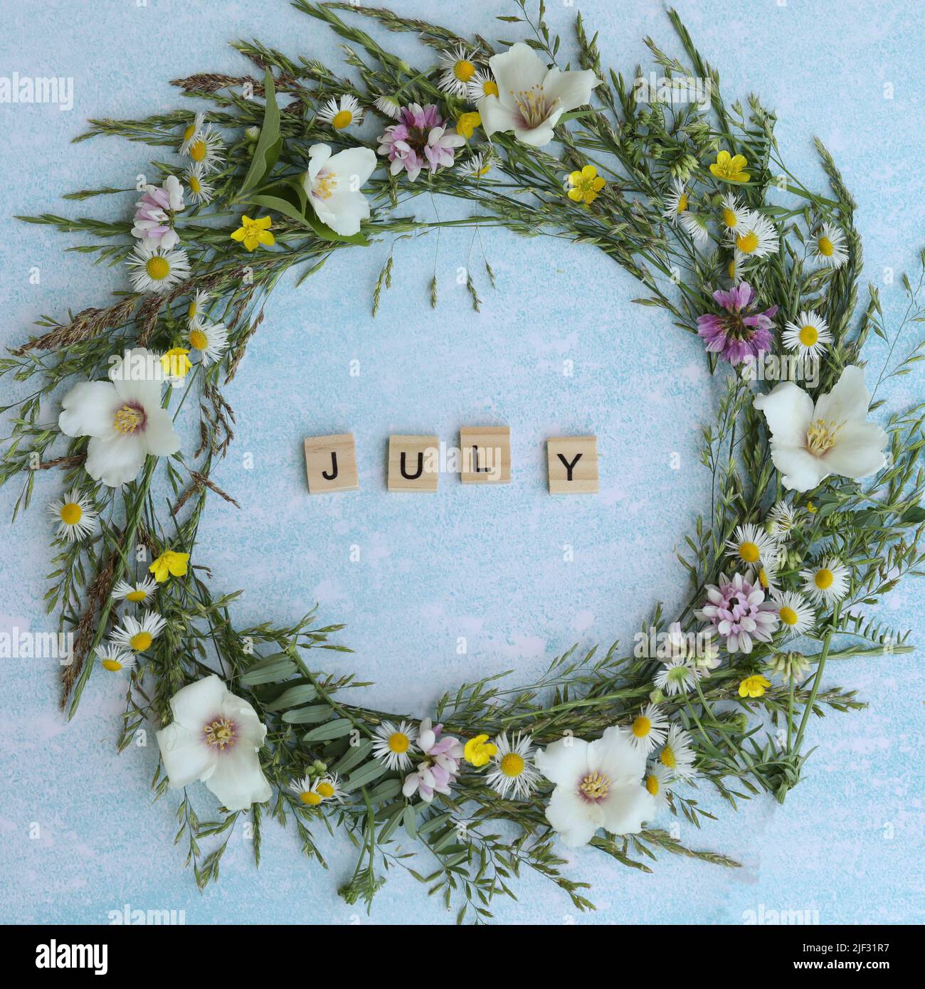 blue background with flowers frame and text. july Stock Photo - Alamy