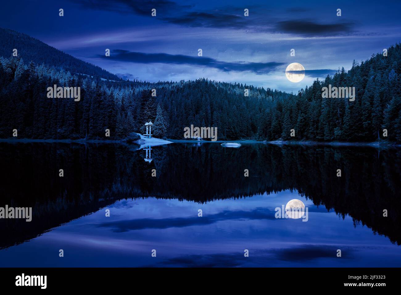 tranquil landscape with lake in summer at night. forest reflection in ...