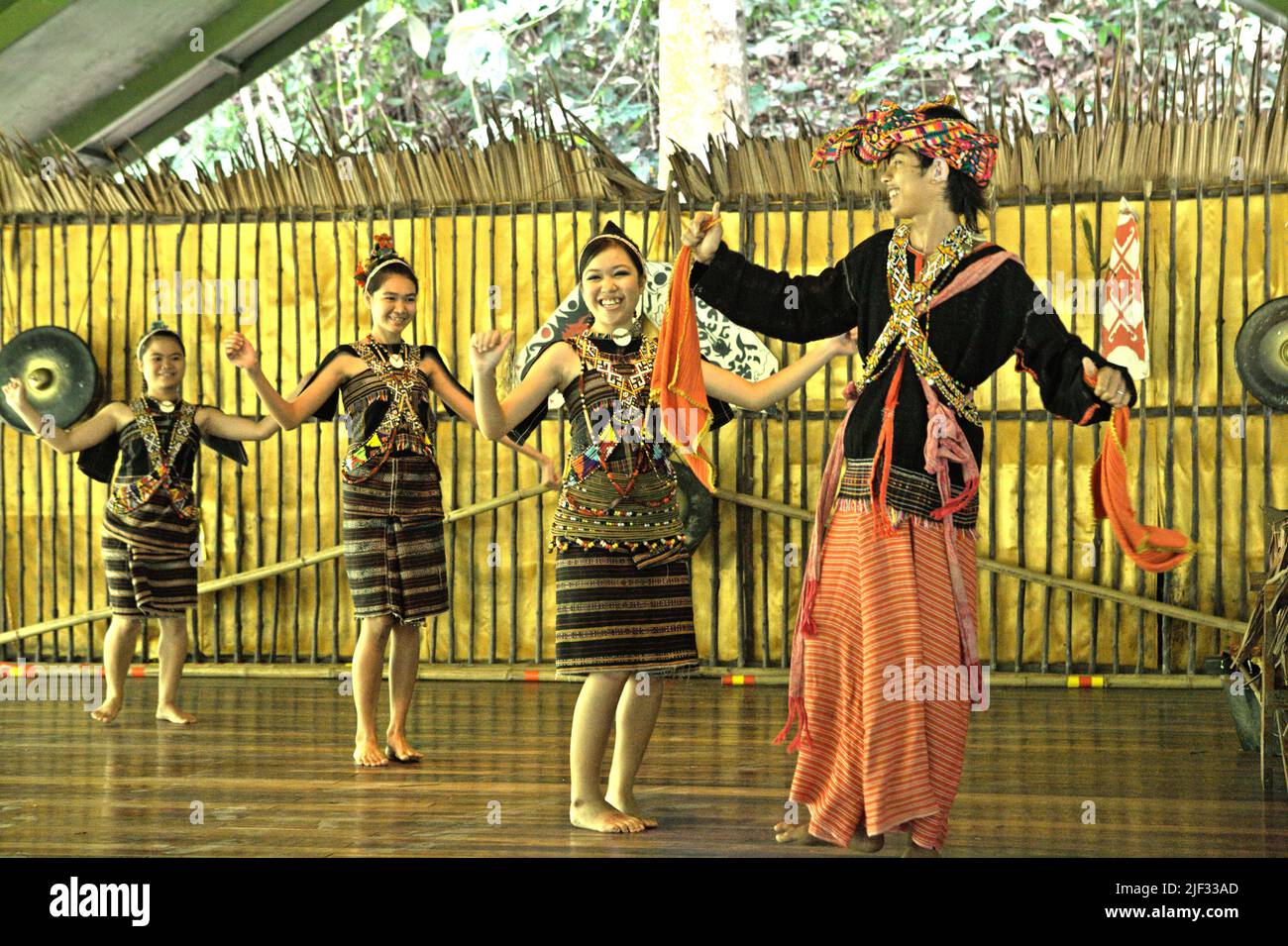 A man and women wearing traditional attires are performing an ...