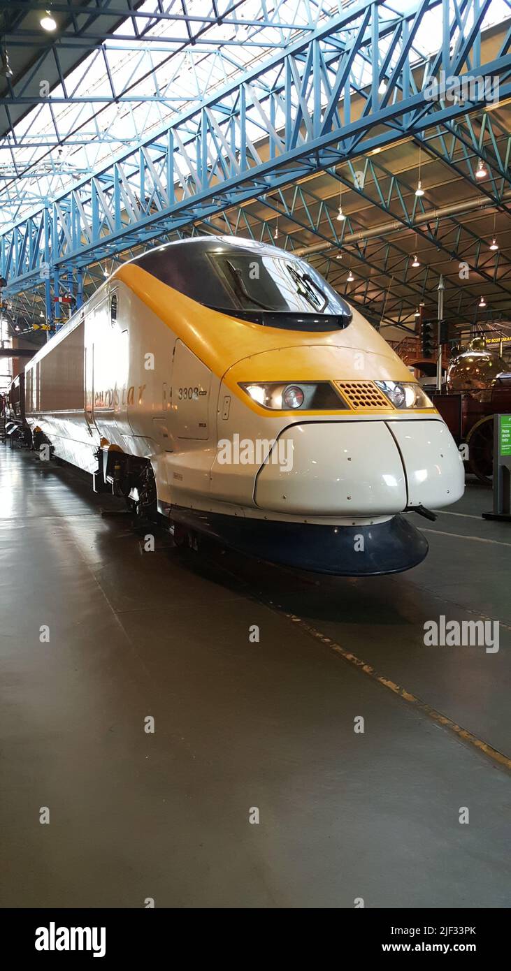 A vertical shot of a modern yellow train accessible to the public at ...