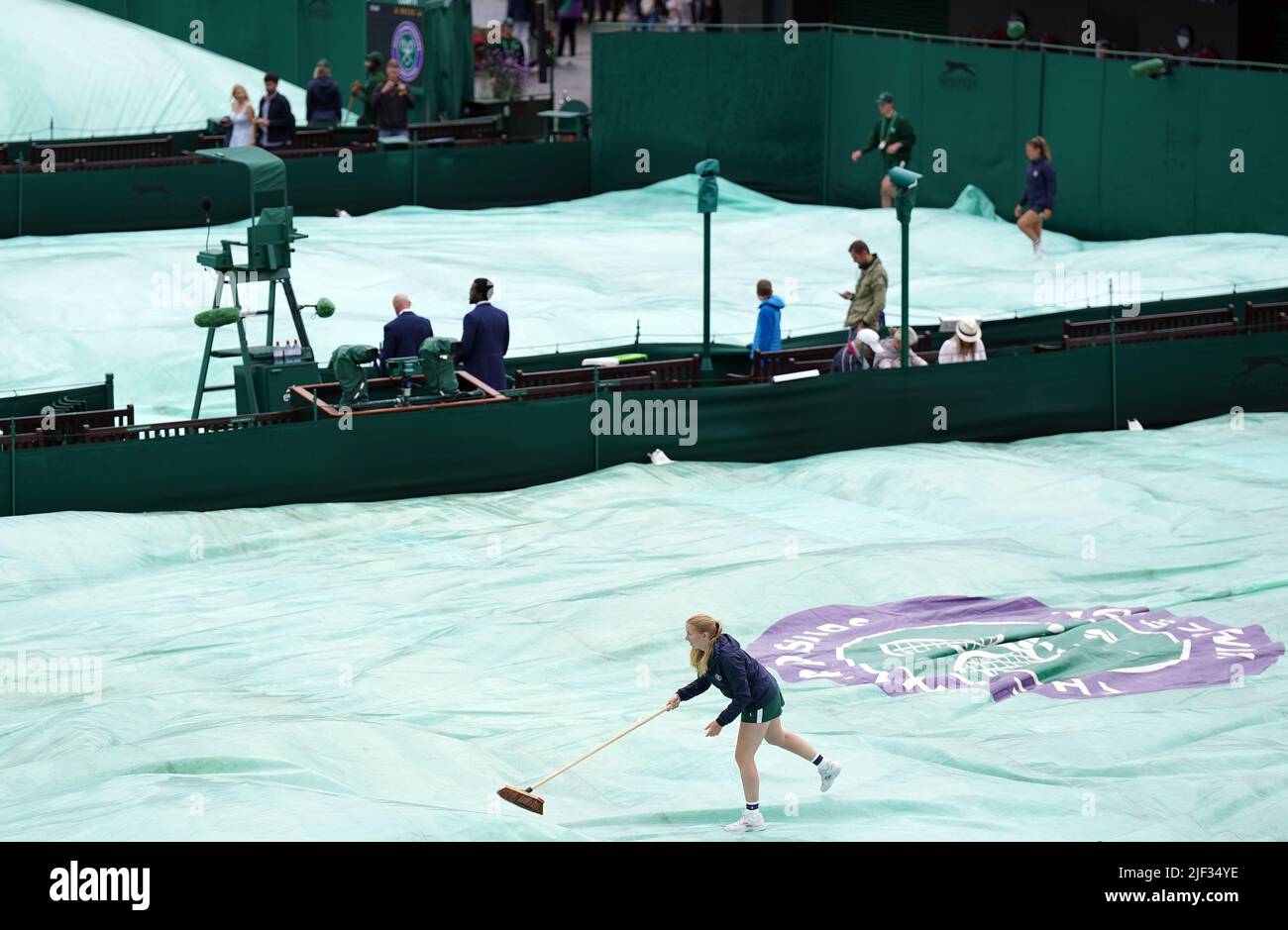 Water is cleared from the outside courts on day three of the 2022 ...