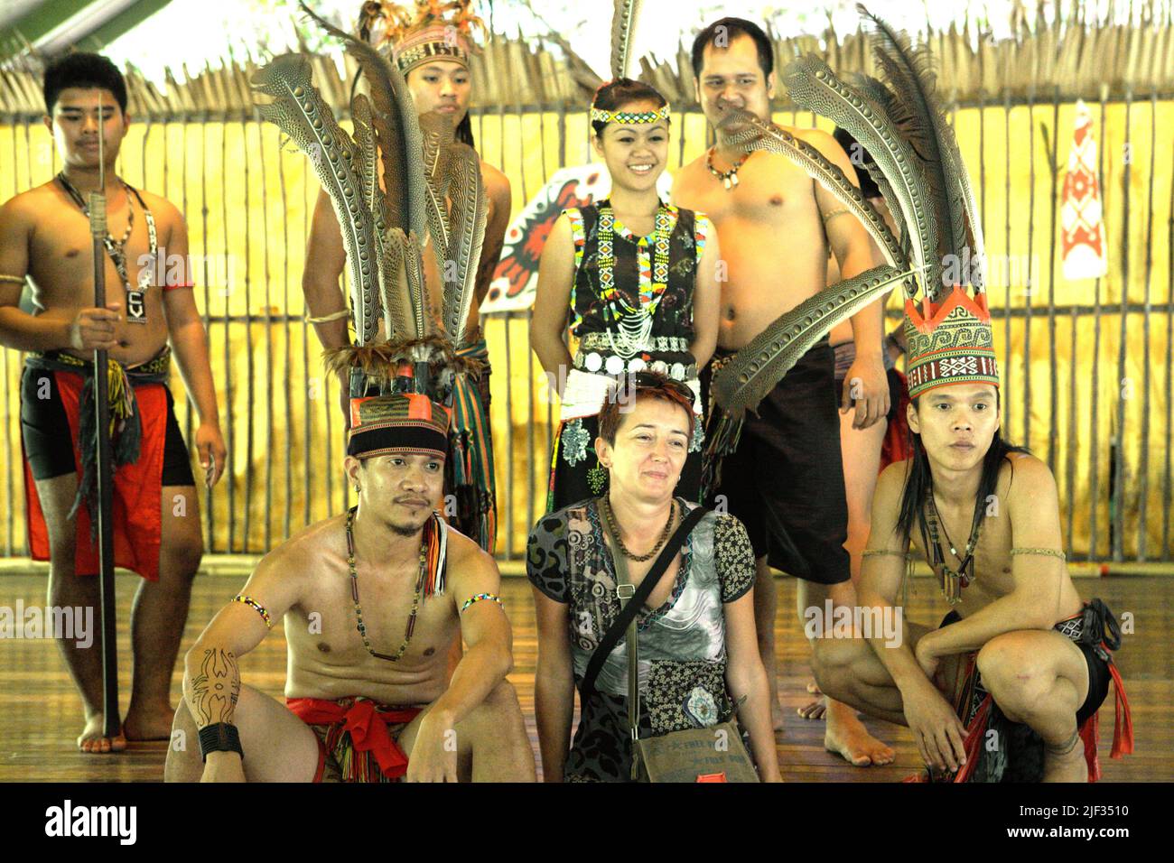 Tourism workers wearing indigenous attires having a photo session with ...