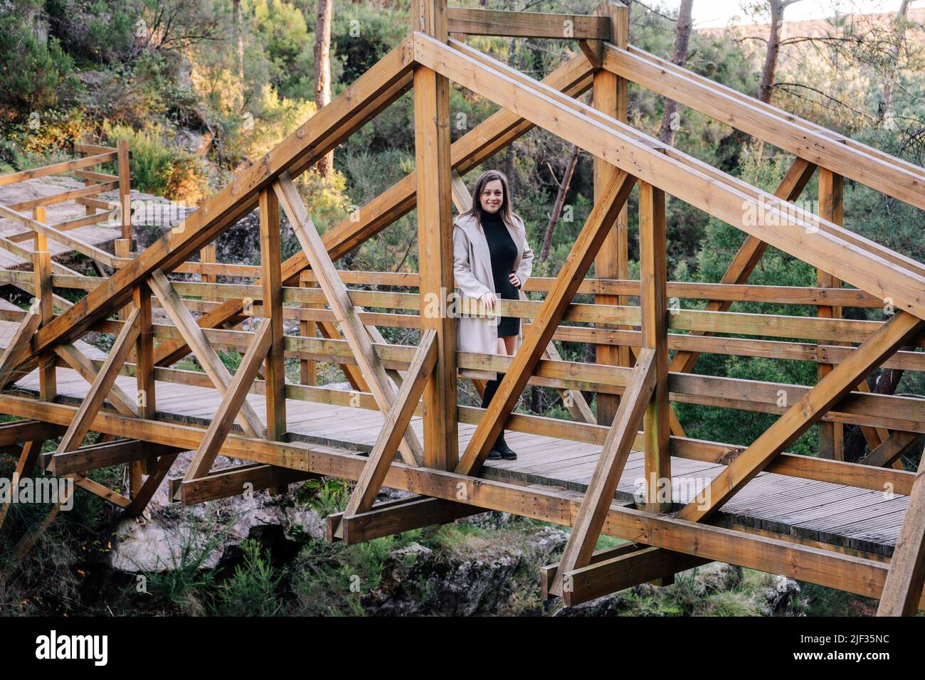 Tourist on a wood bridge over a forest in Galicia, Spain Stock Photo - Alamy