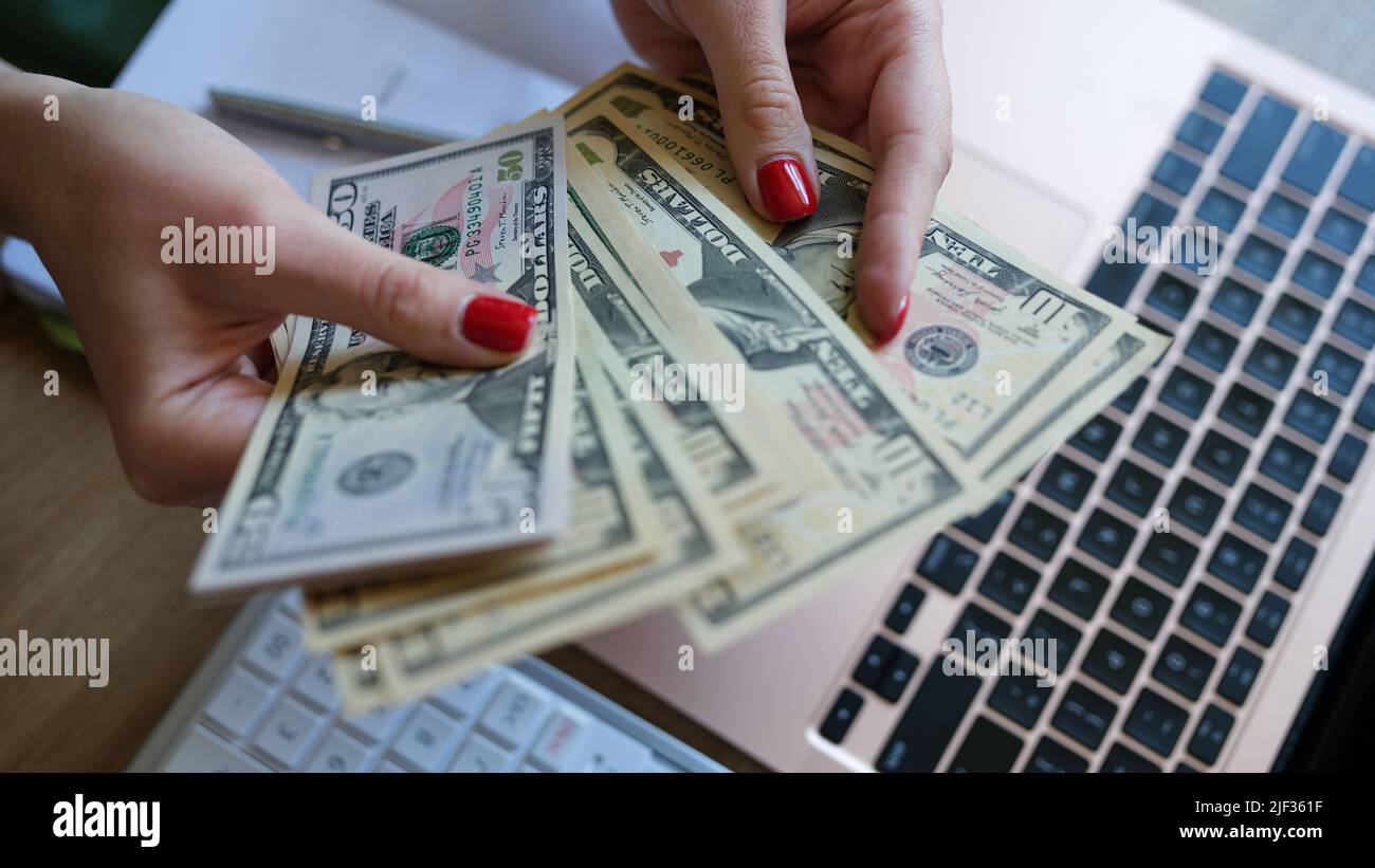 Dollar bills in female hands hi-res stock photography and images - Alamy