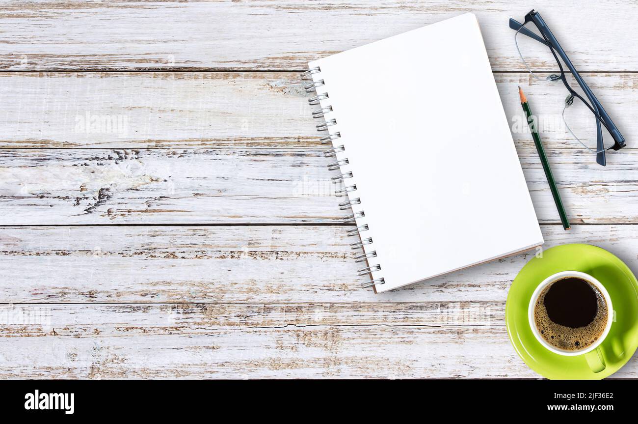 Blank notepad,glasses and pencil with cup of coffee on office wood ...