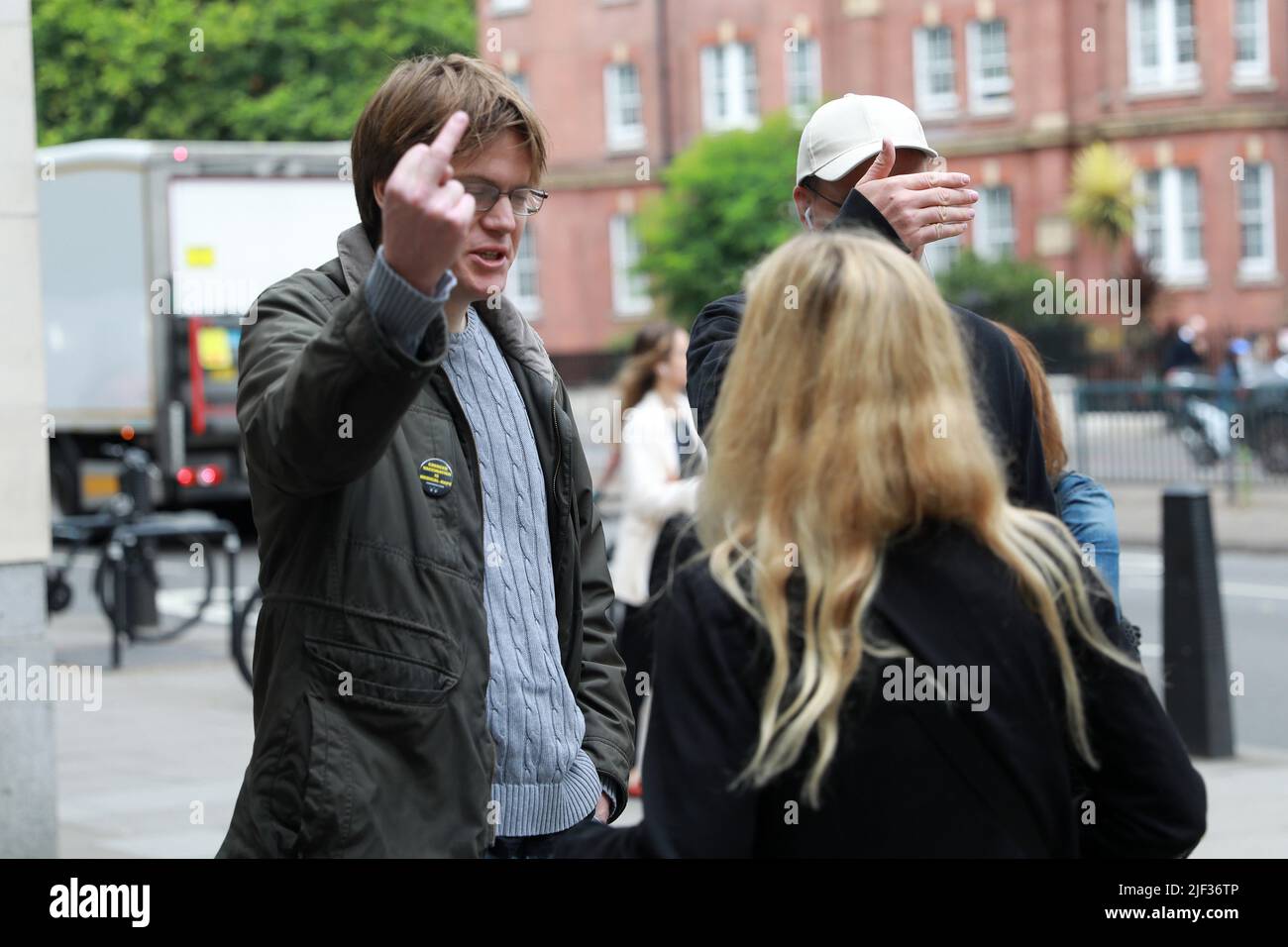 EDITORS NOTE GESTURE Alexander Peat (left) arrives at Westminster ...