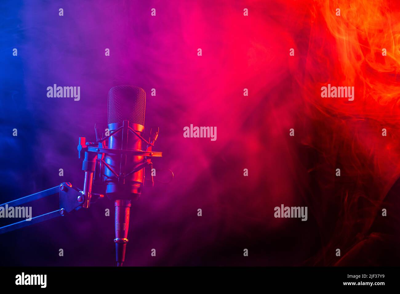 Professional microphone in pink smoke on a black background Stock Photo ...