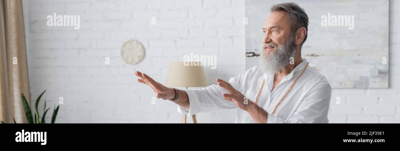 bearded master guru looking away while meditating with outstretched ...