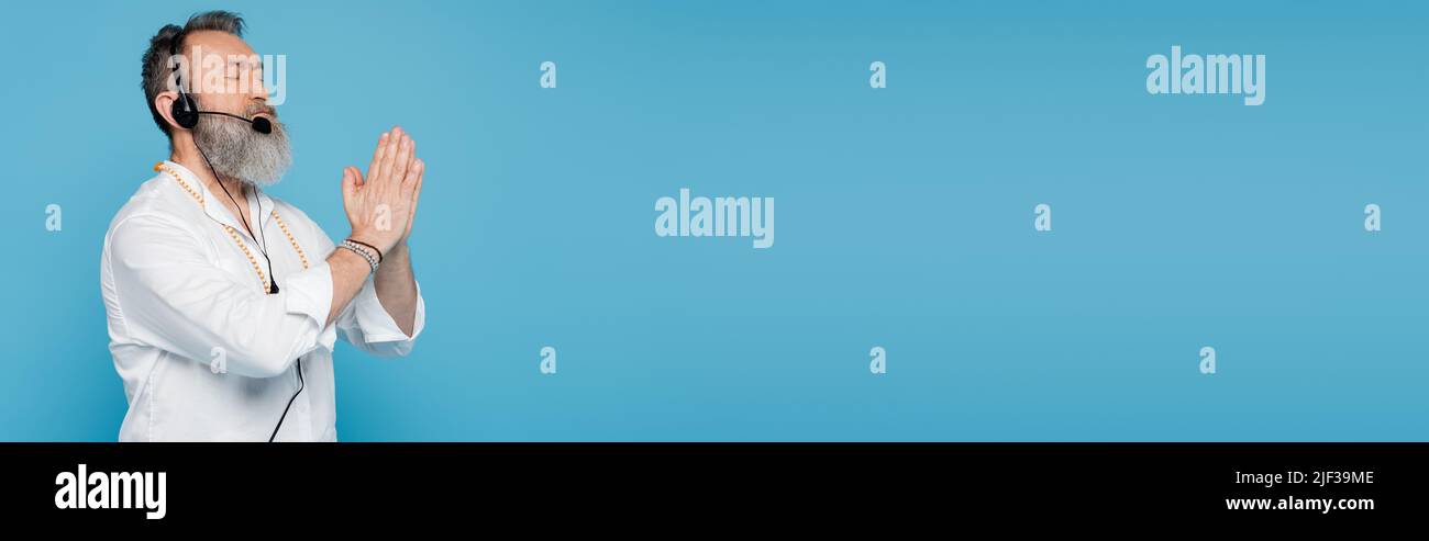 bearded guru man in headset meditating with praying hands isolated on ...